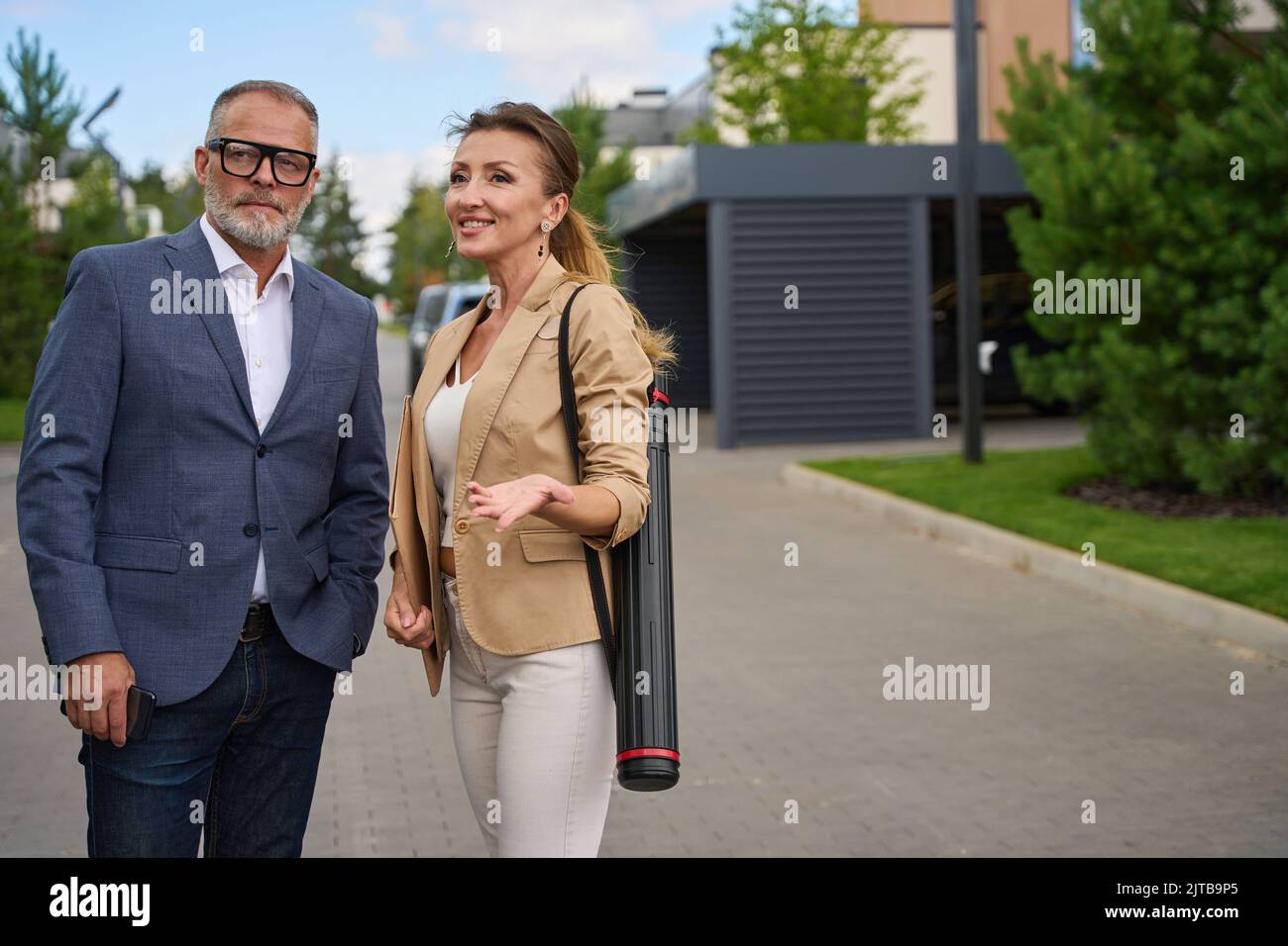 Real estate agent and client meeting for house showing Stock Photo - Alamy