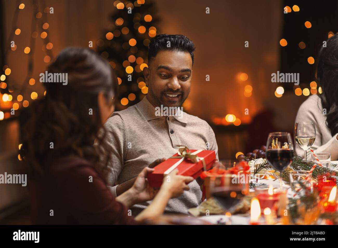Smiling family sharing christmas presents hi-res stock photography and ...