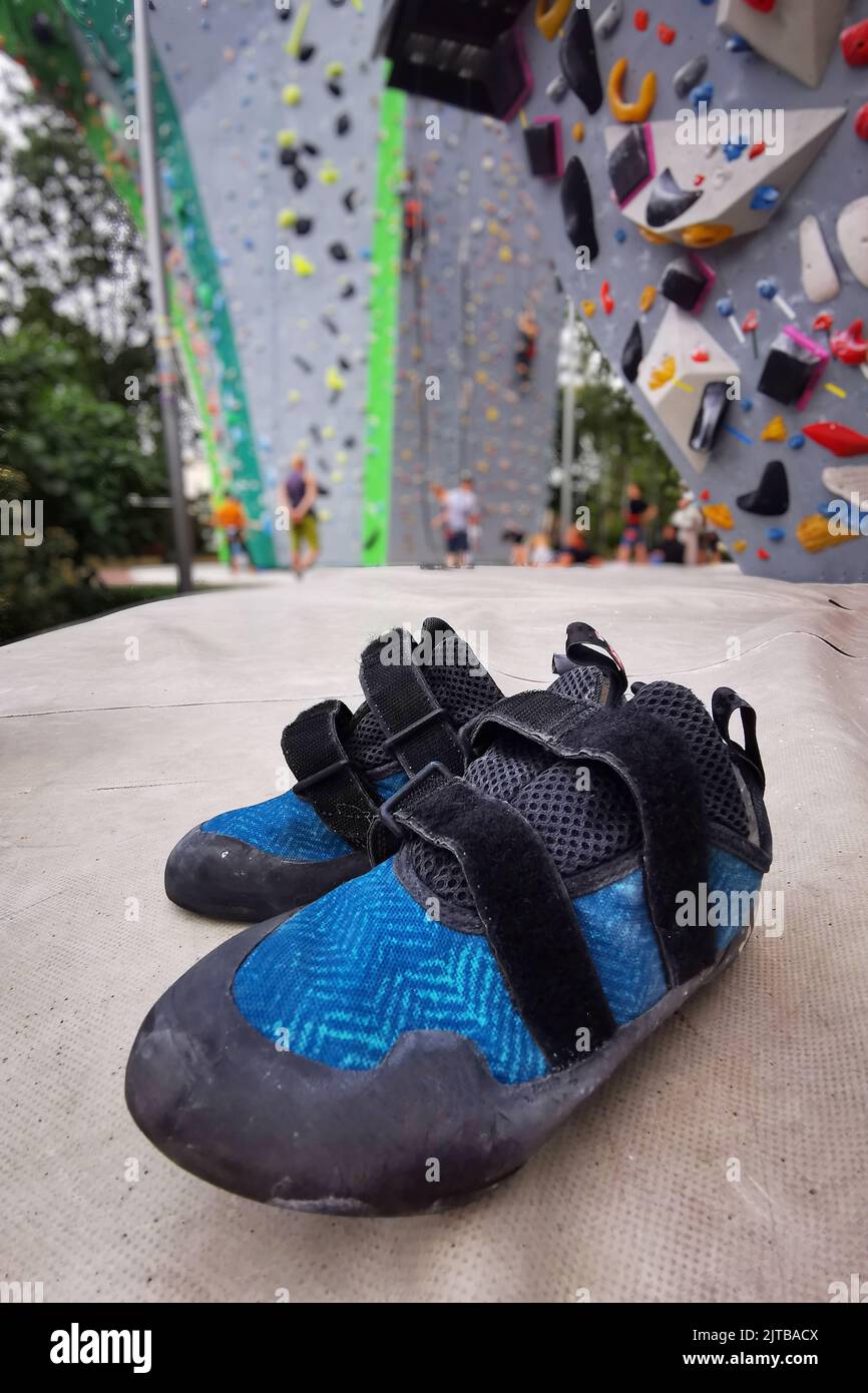 Rock shoes on against background rock climbing bouldering wall with ...