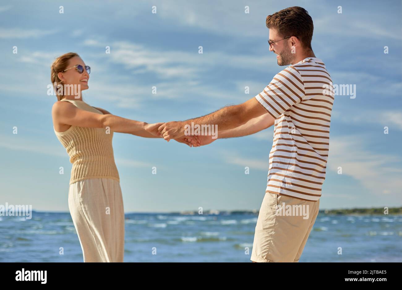 happy couple having fun on summer beach Stock Photo - Alamy