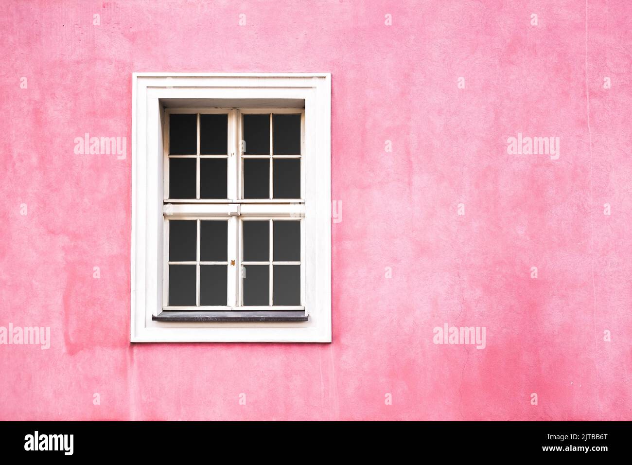 Renaissance style window with white frame on pink wall color. Building ...