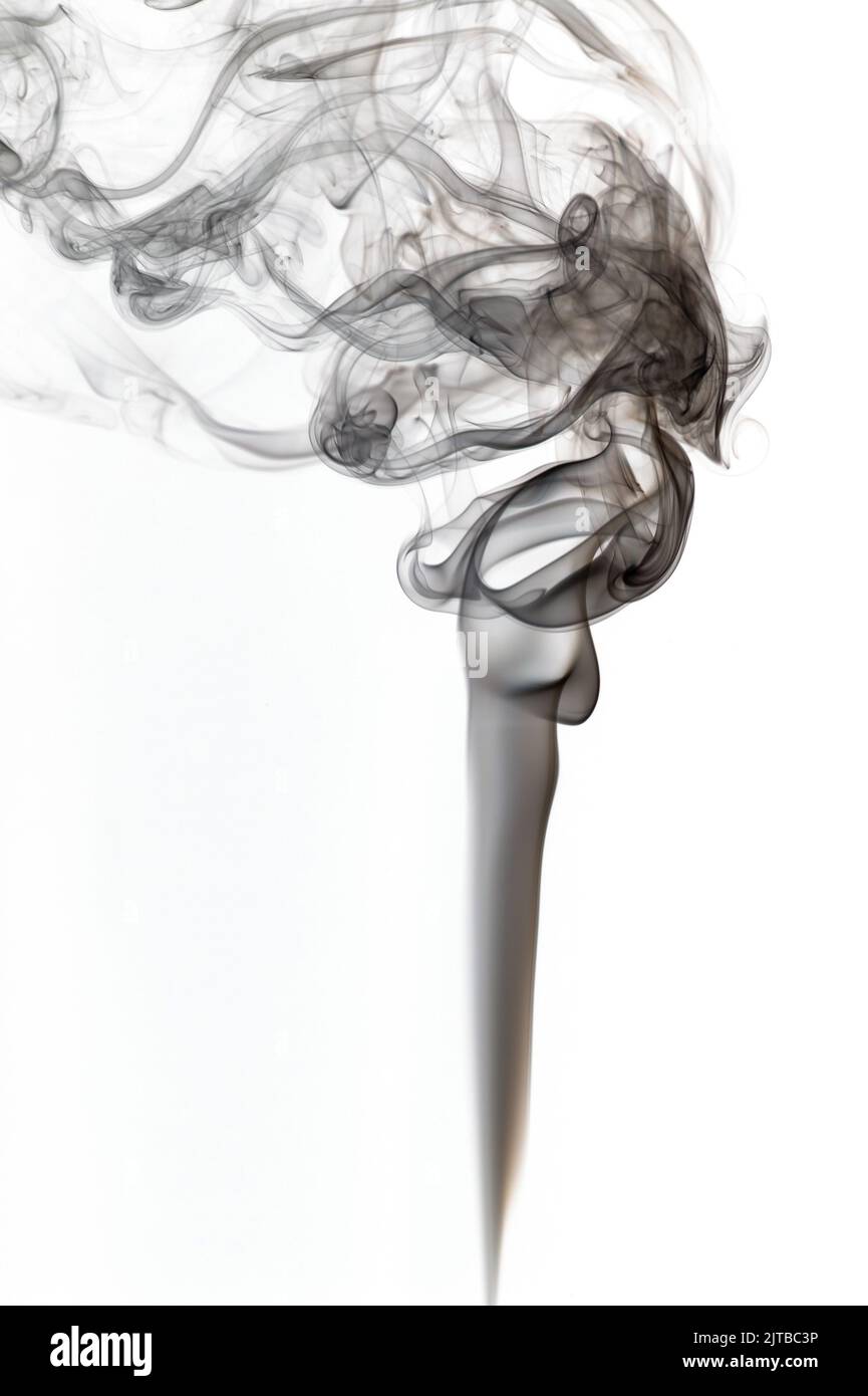 Puffs and curls of dark smoke on a white background rising from a ...