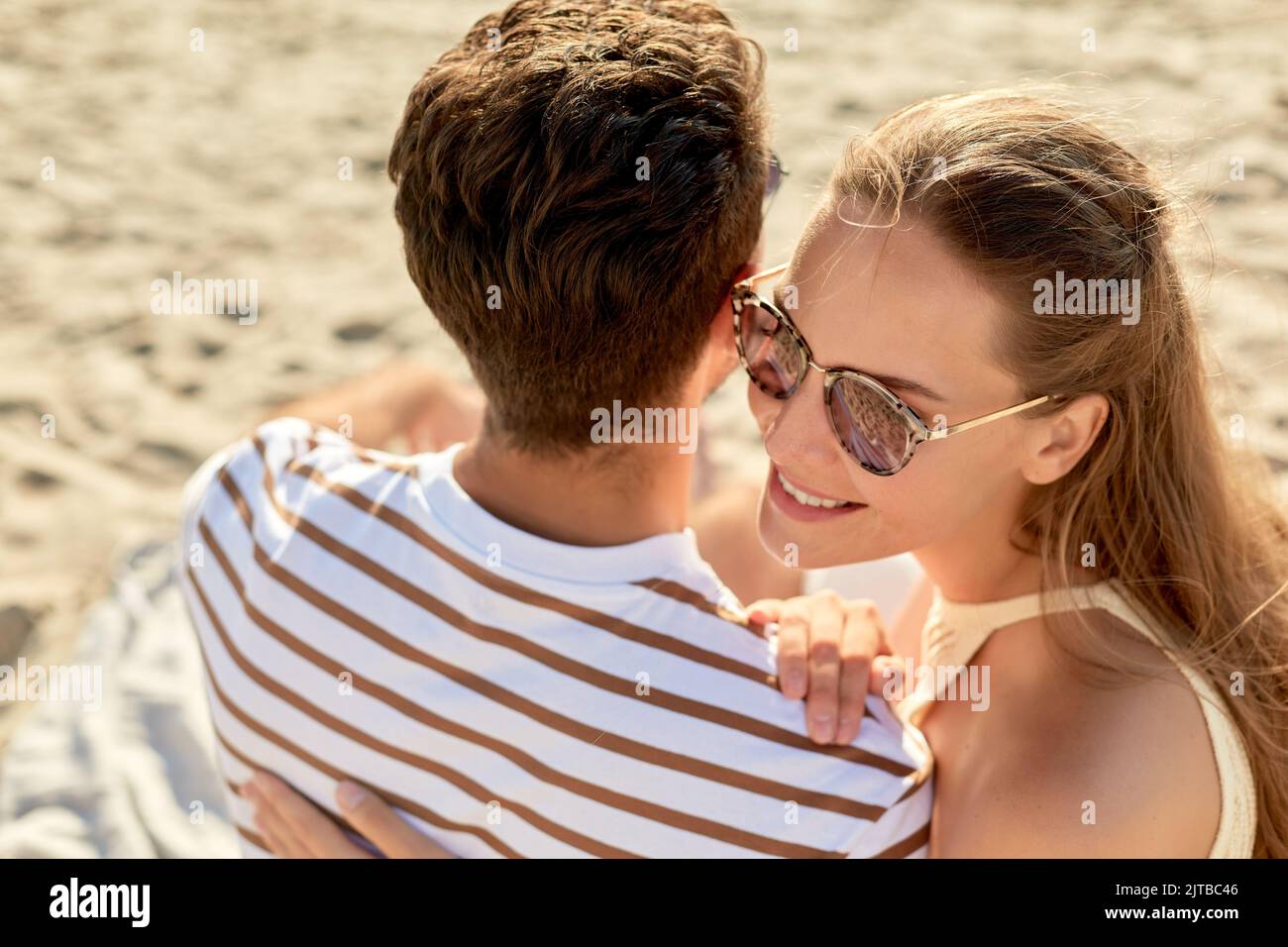 happy couple chilling on summer beach Stock Photo - Alamy