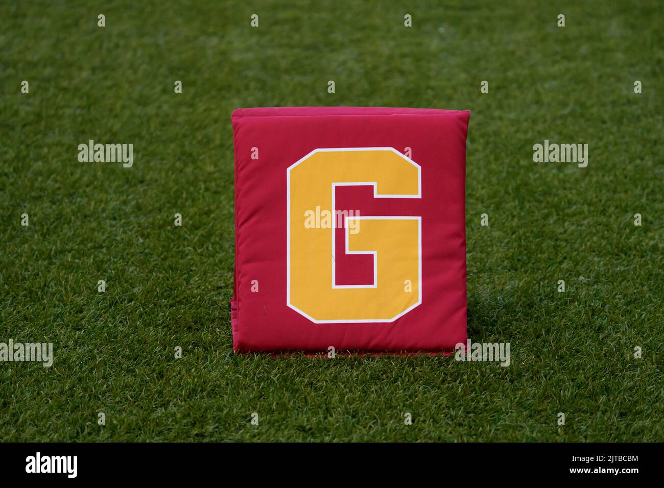 Close-up detail of a yard marker standing on a soccer field. Team sport ...