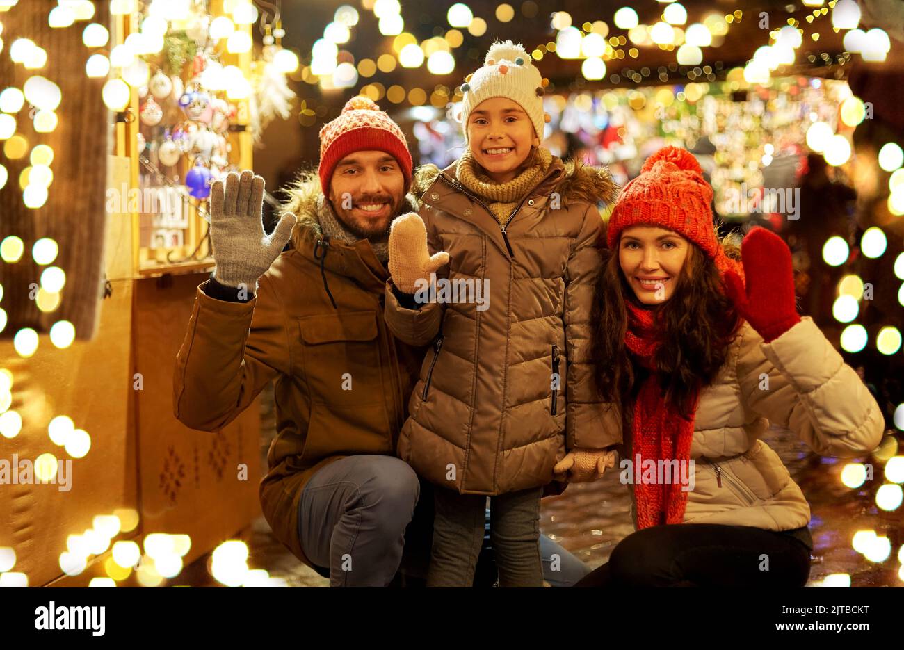 happy family waving hands at christmas market Stock Photo - Alamy