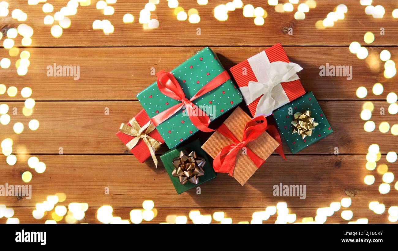 christmas gifts on wooden boards over lights Stock Photo - Alamy