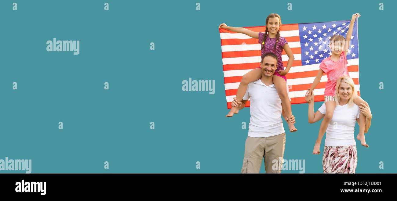 Happy young family with national flags of USA near blue wall Stock ...