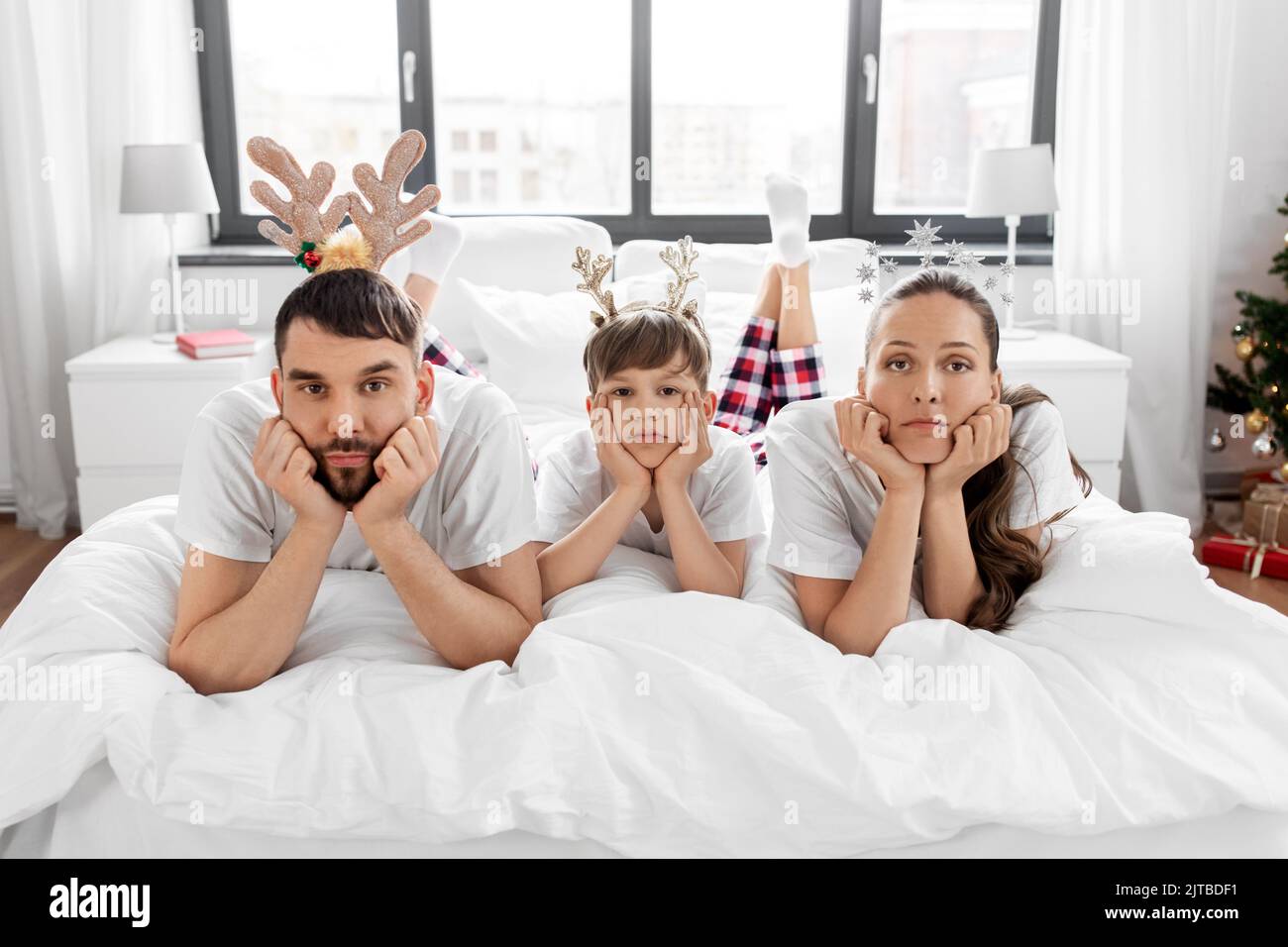 sad family in bed in christmas morning Stock Photo - Alamy