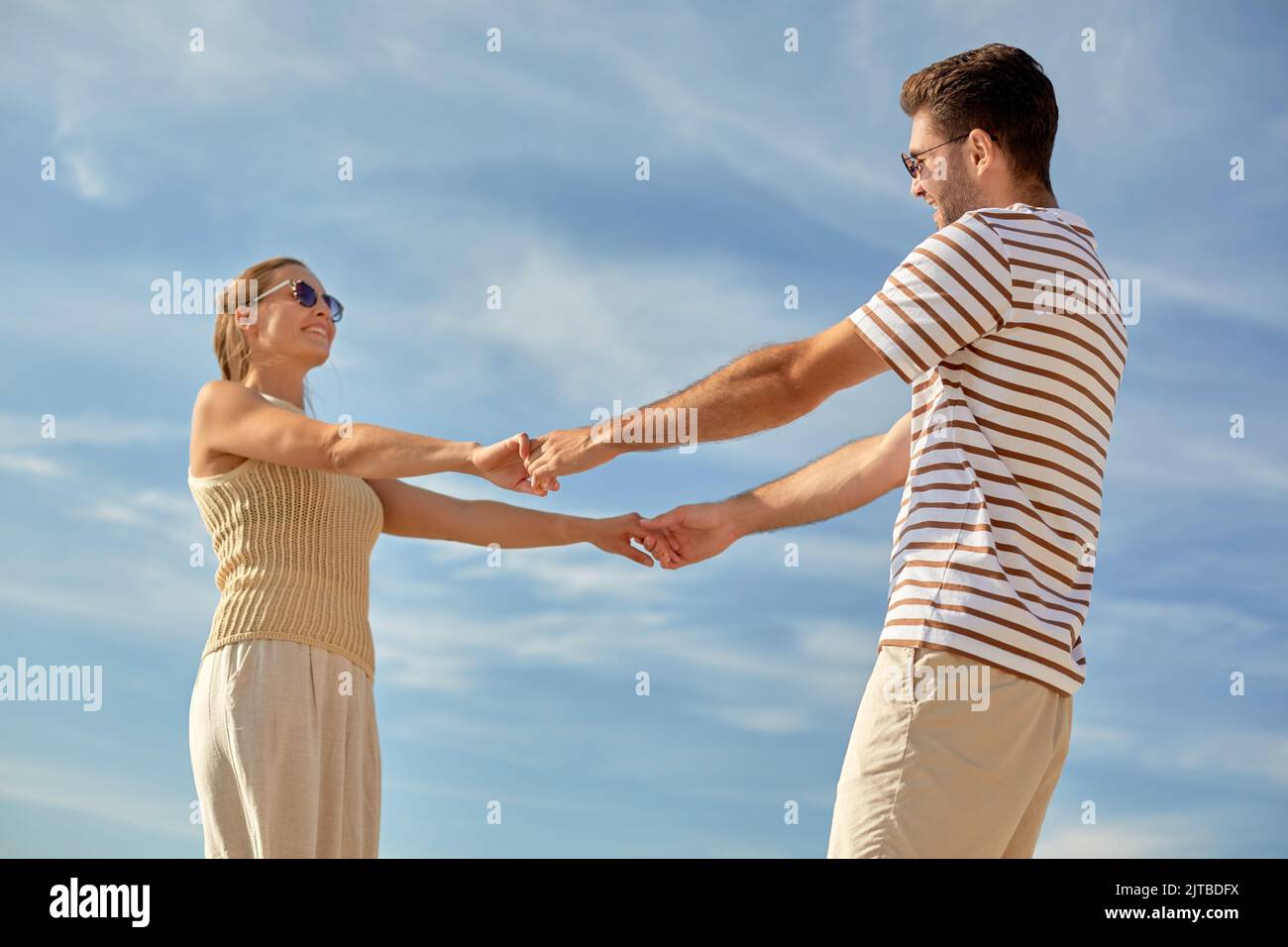 happy couple holding hands outdoors Stock Photo - Alamy