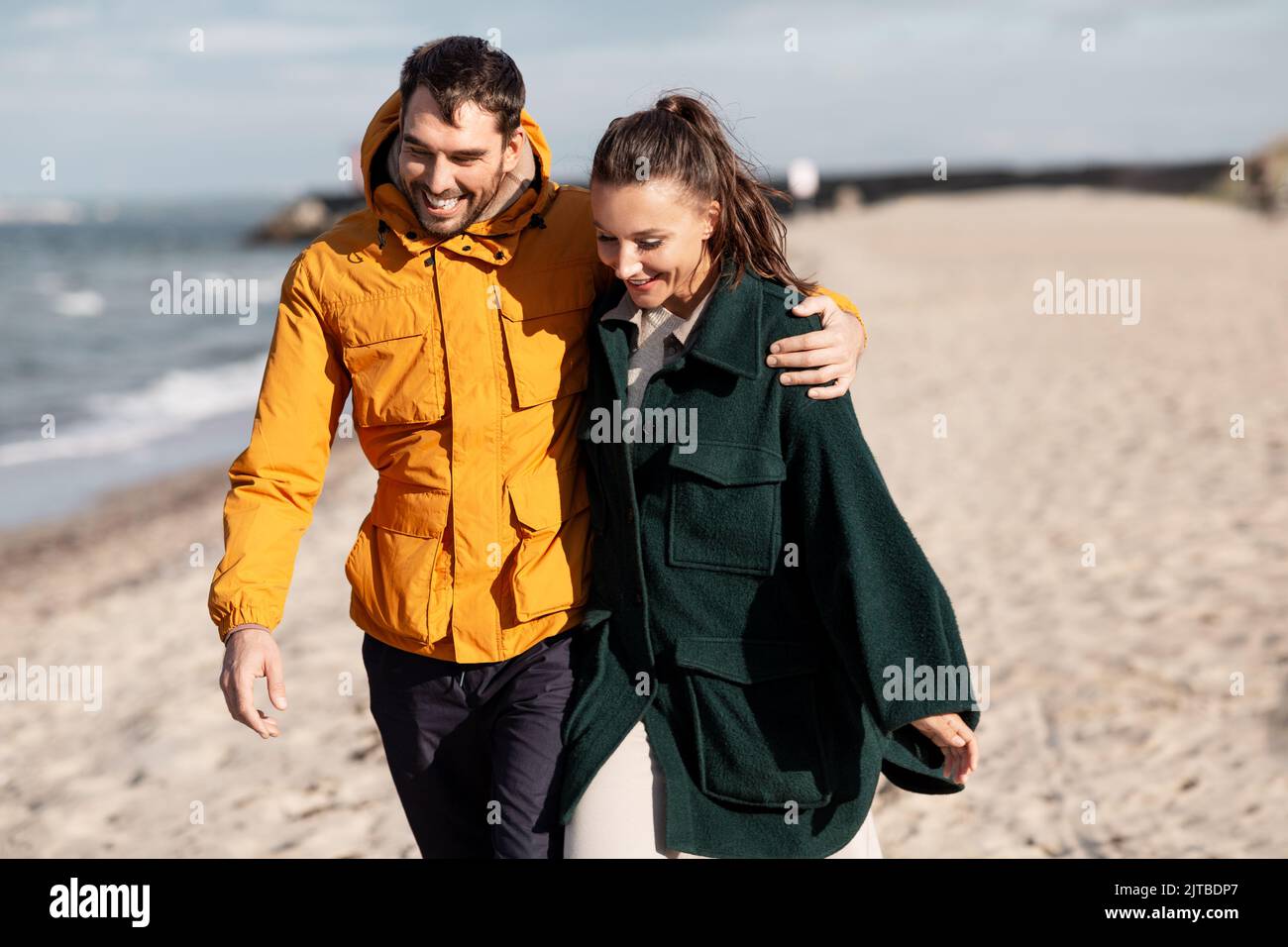 Romantic couple embracing walking along hi-res stock photography and ...