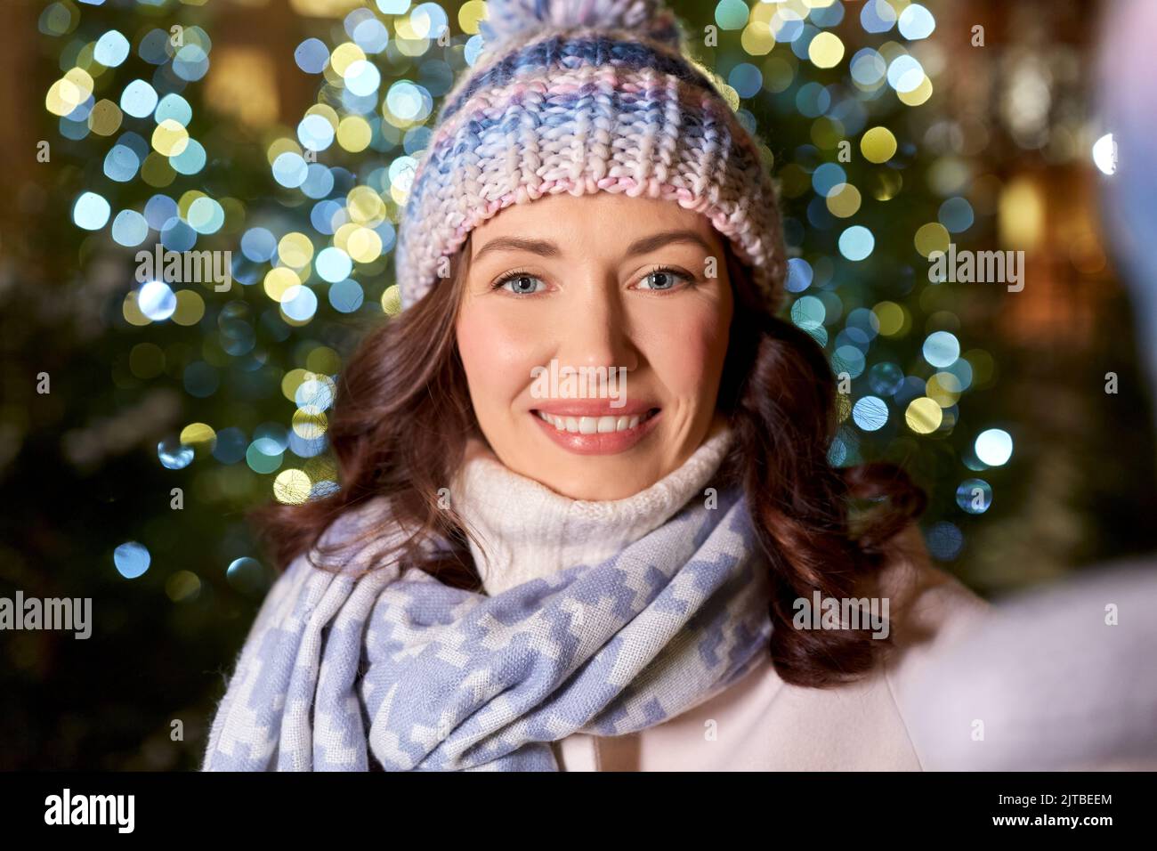 happy woman taking selfie over christmas lights Stock Photo - Alamy