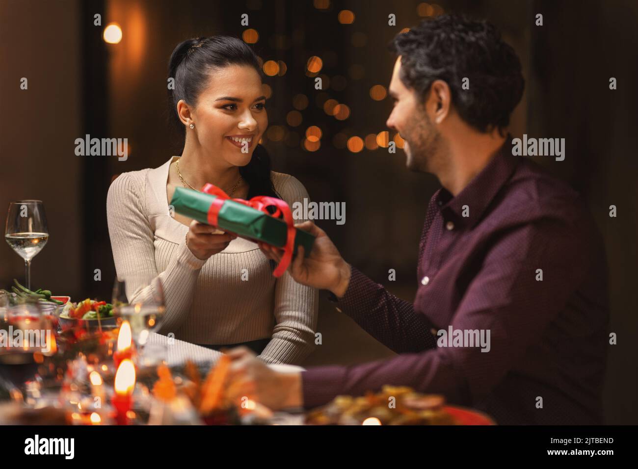happy friends giving christmas presents at home Stock Photo - Alamy