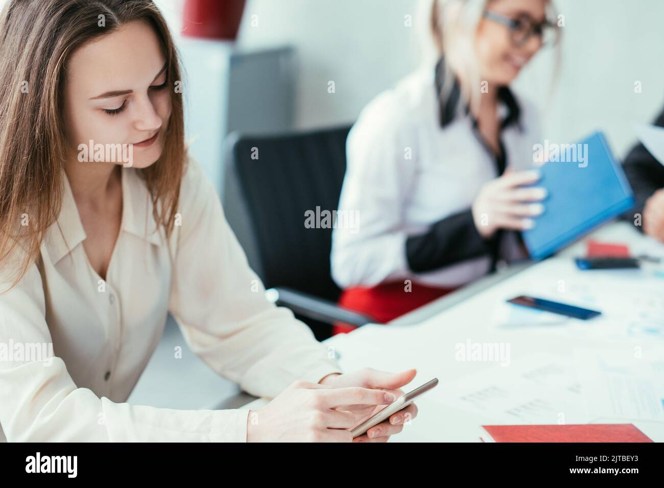 bored work team member slack browse smartphone Stock Photo - Alamy