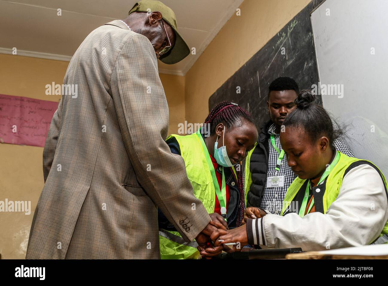 Election officials confirm a voter’s biometric details using a ...