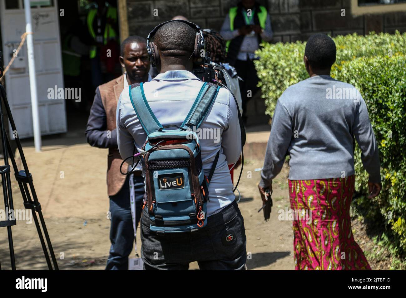 A TV reporter does a live telecast of the delayed Member of Parliament ...