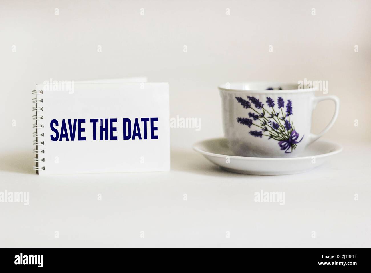 Text Save the date written on notepad and white background with ...