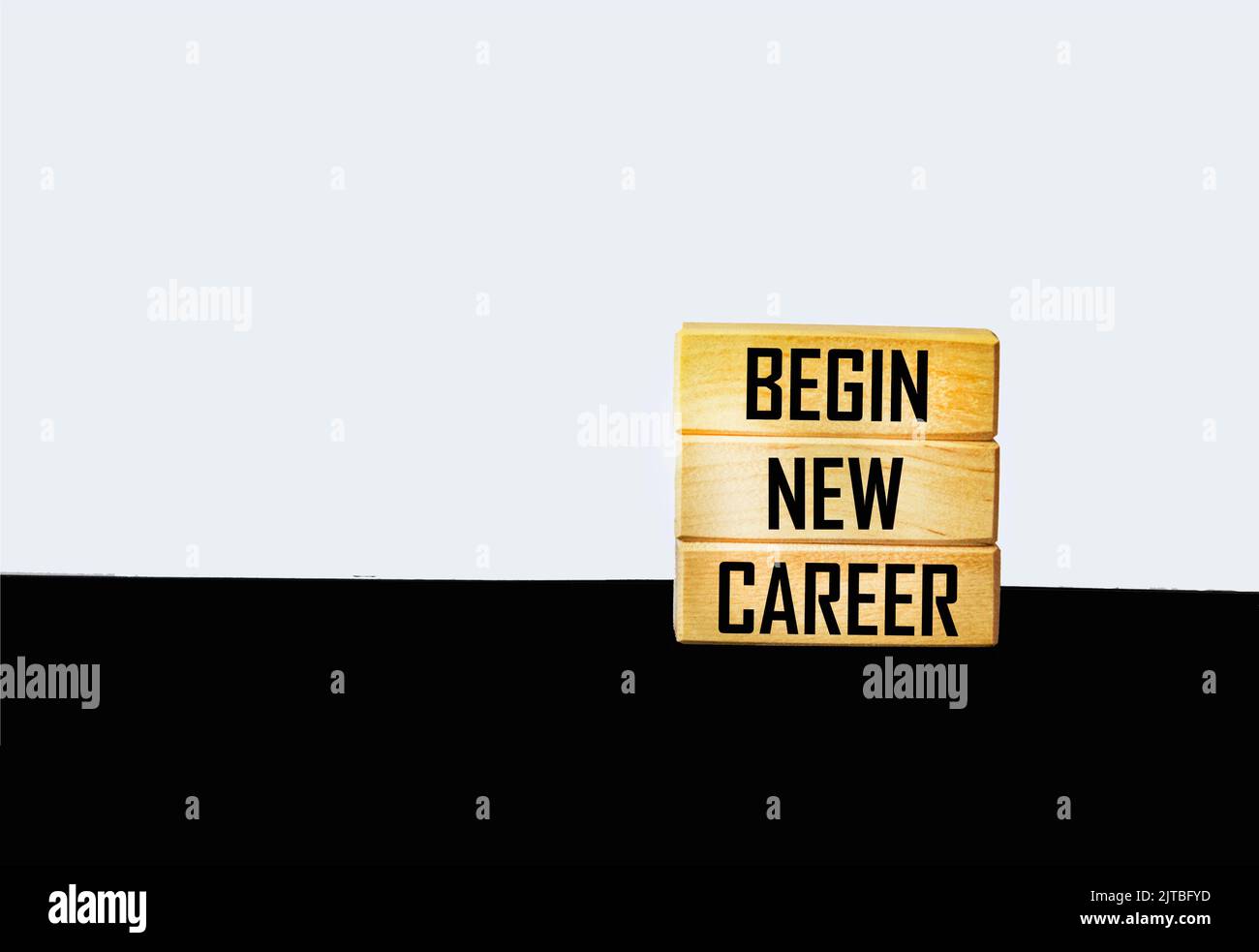 BEGIN A NEW CAREER text on wooden blocks on white and black background ...