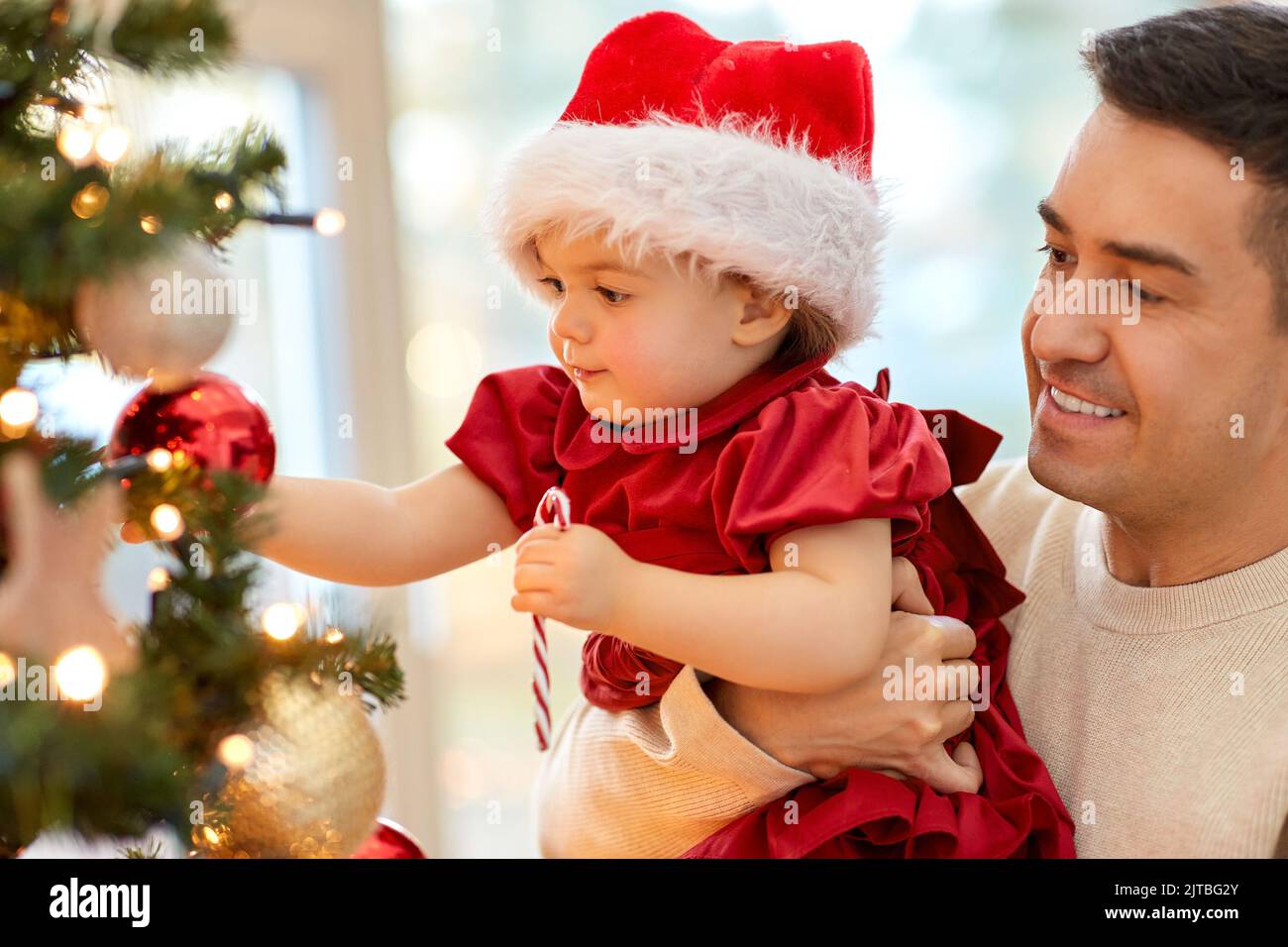happy father and baby girl decorate christmas tree Stock Photo - Alamy