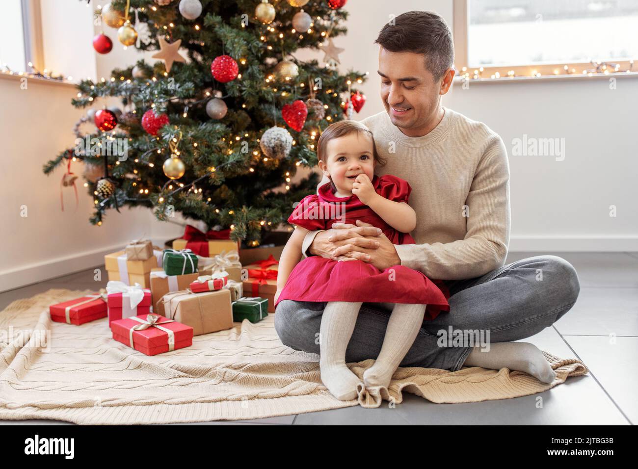 happy father and baby girl over christmas tree Stock Photo - Alamy