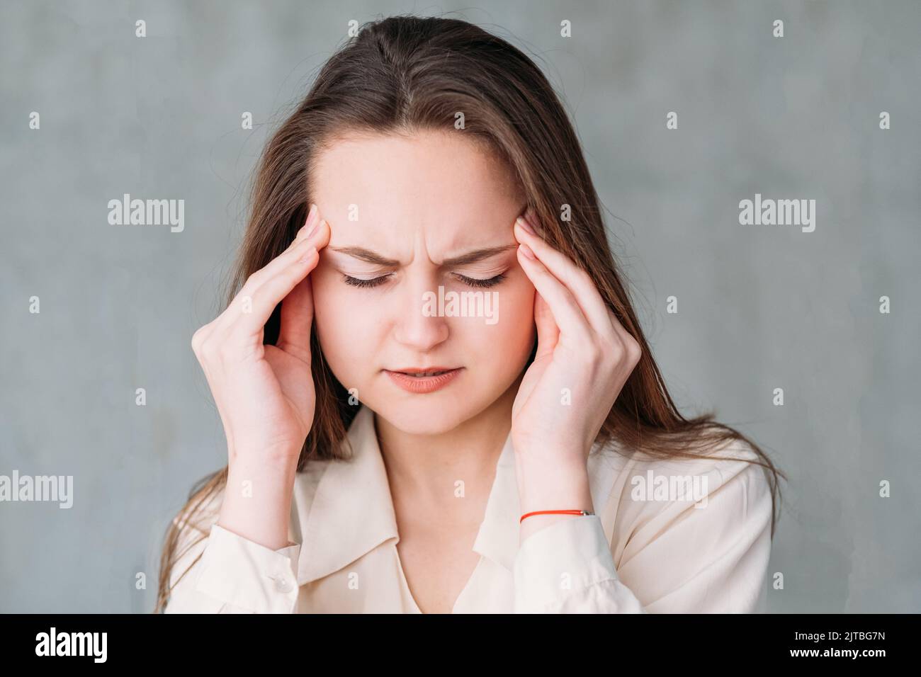 young woman portrait stress headache touch temple Stock Photo - Alamy