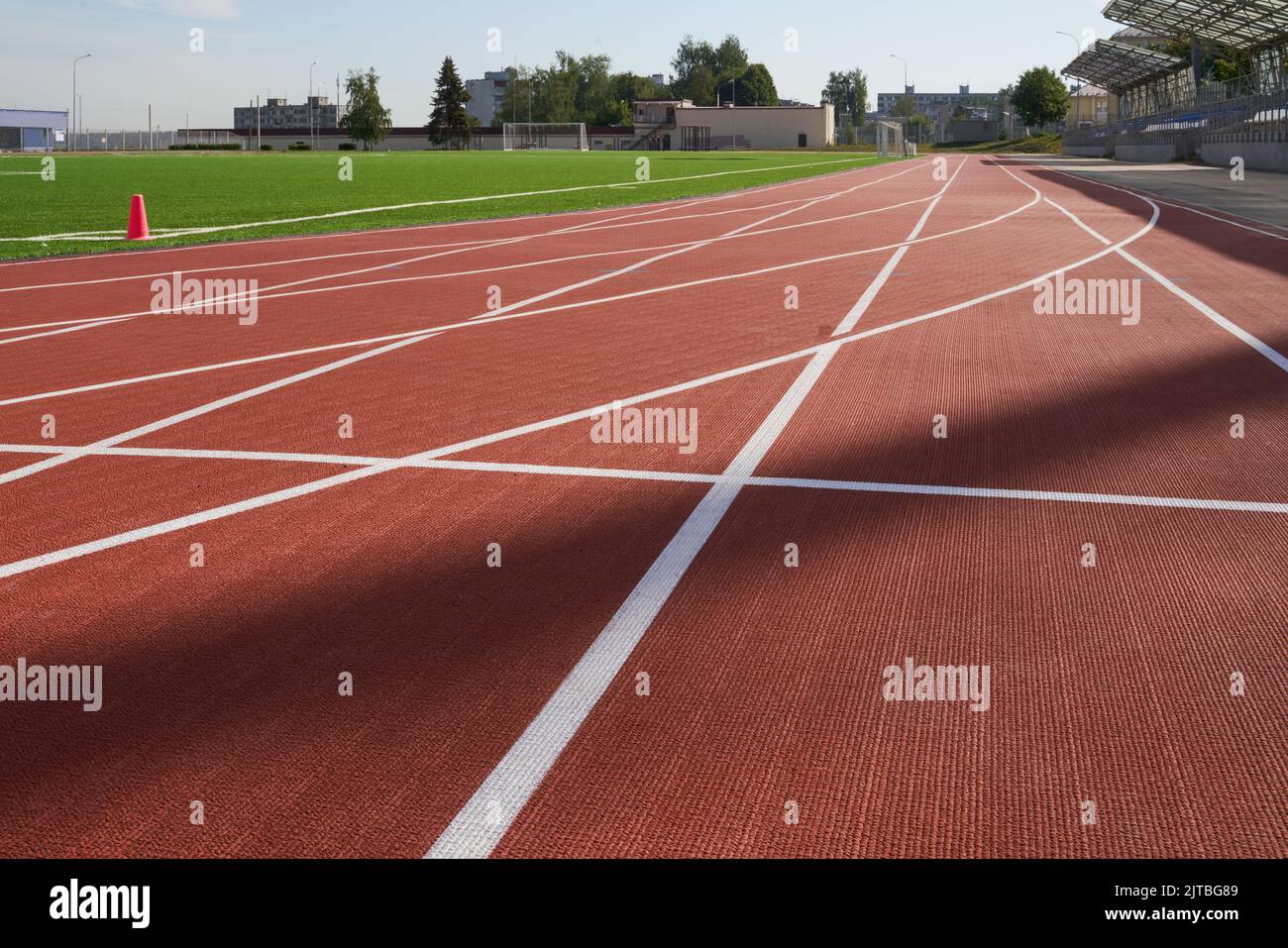 Running track. Red treadmill at the stadium with white lines. Concept ...