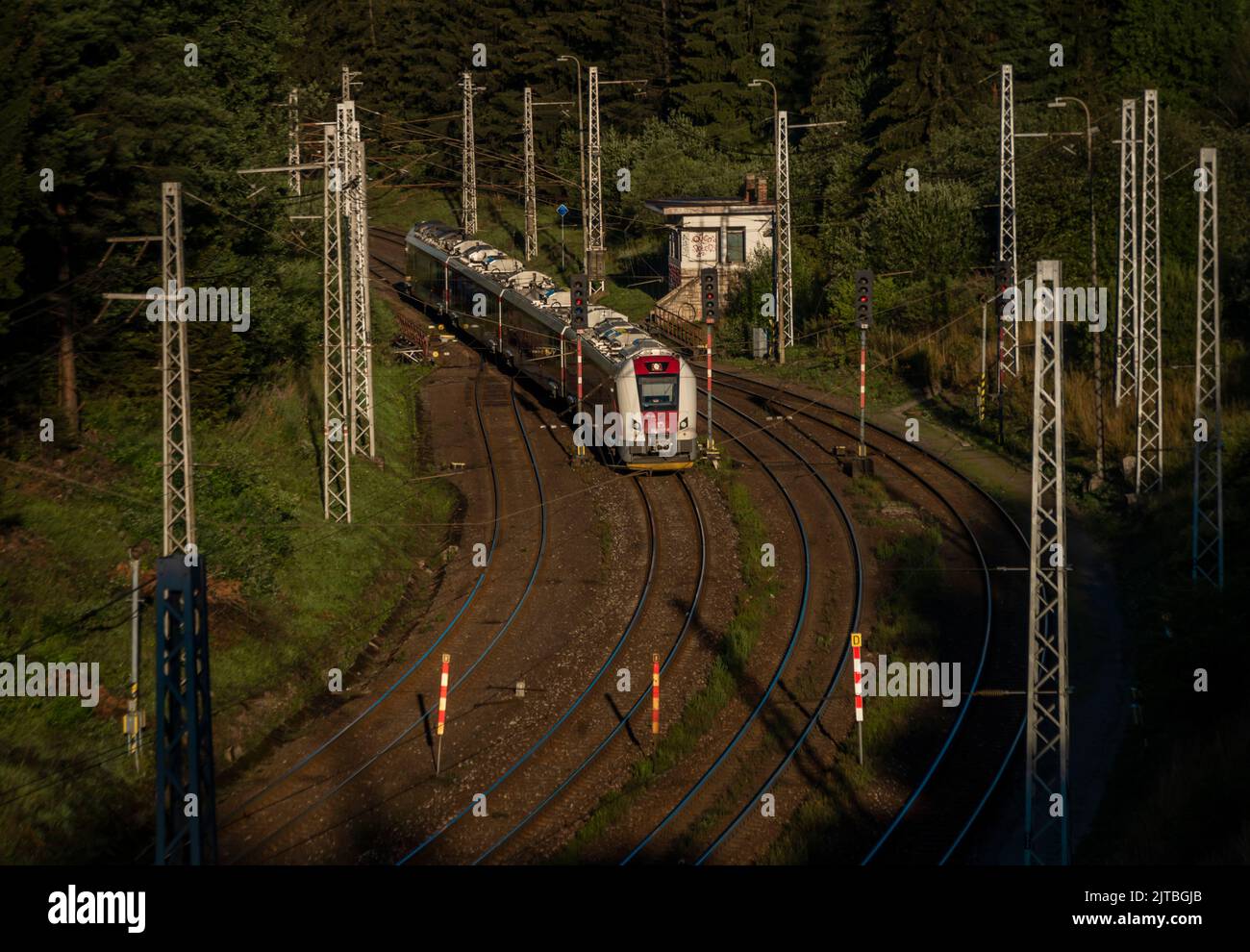 Passenger electric train coming to station Strba in Slovakia montains ...