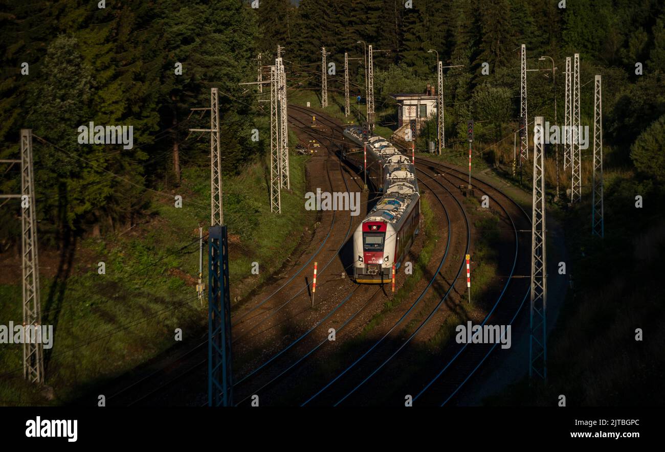 Passenger electric train coming to station Strba in Slovakia montains ...