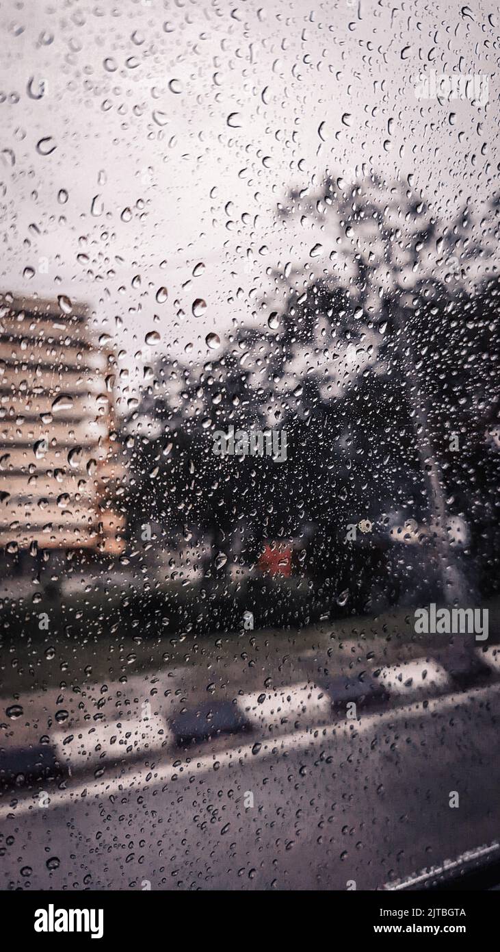 A vertical shot through a wet window from a car Stock Photo - Alamy