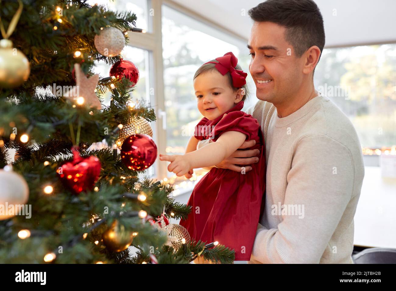 happy father and baby girl decorate christmas tree Stock Photo - Alamy
