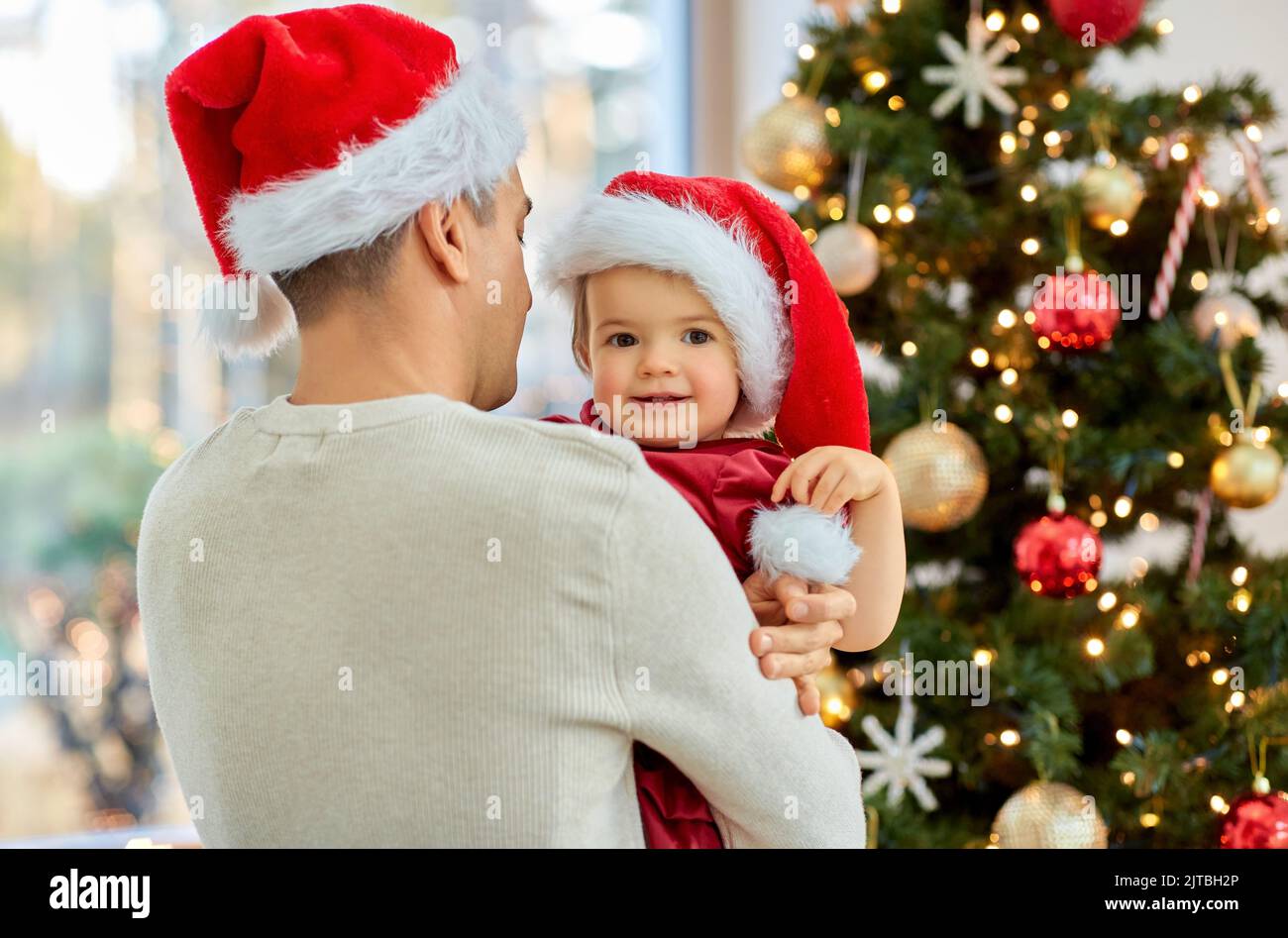 happy father and baby girl over christmas tree Stock Photo - Alamy