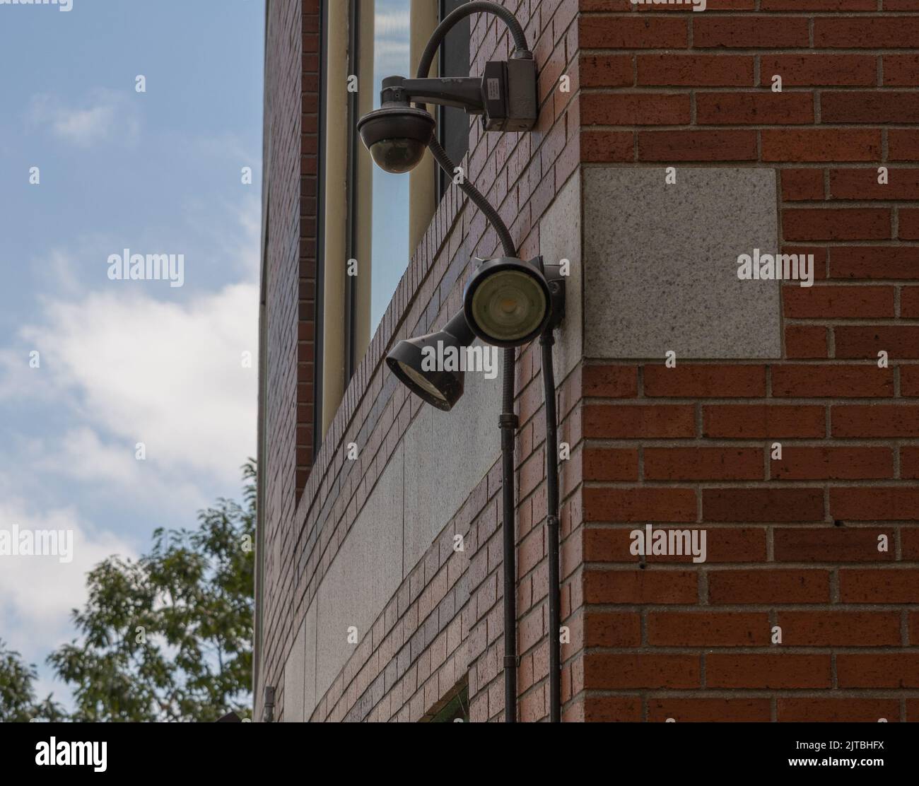 A security camera outside of building Stock Photo - Alamy
