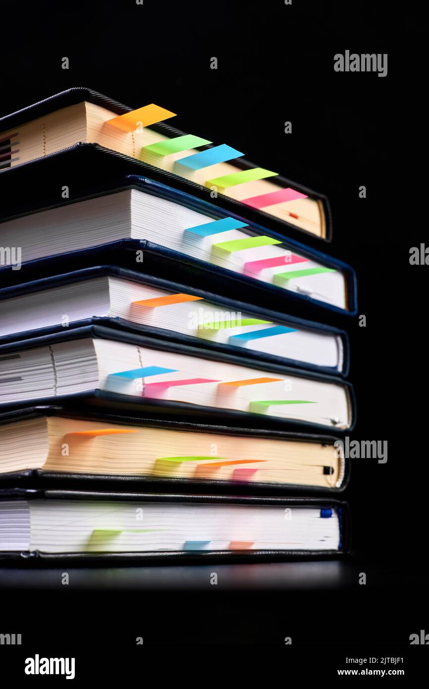 Close-up of a stack of office notepads with colorful sticky page ...