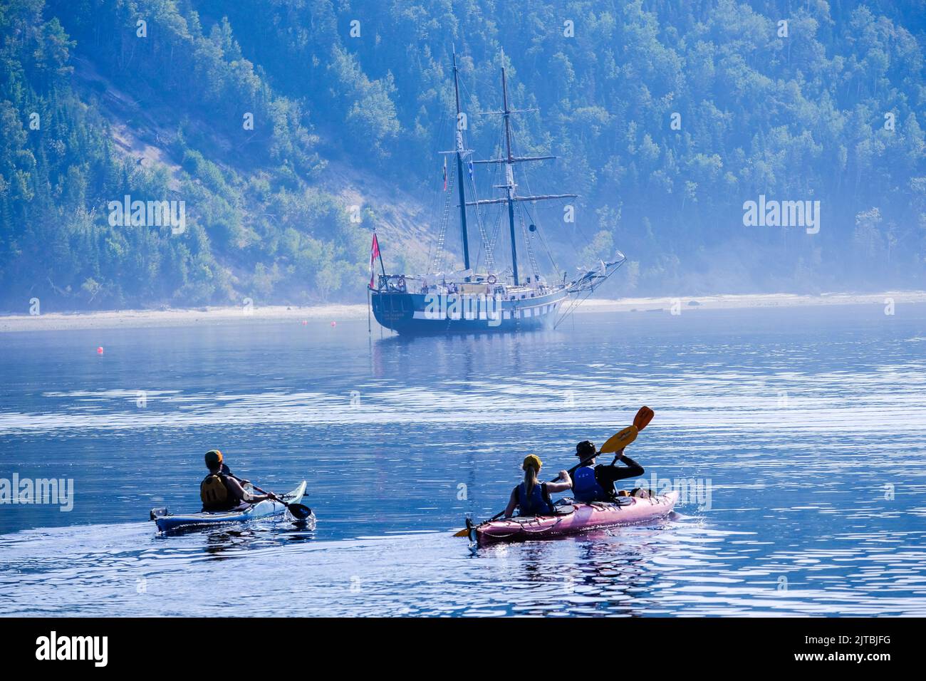 Sea kayaks heading out from harbor in Tadoussac, Quebec, Canada Stock ...