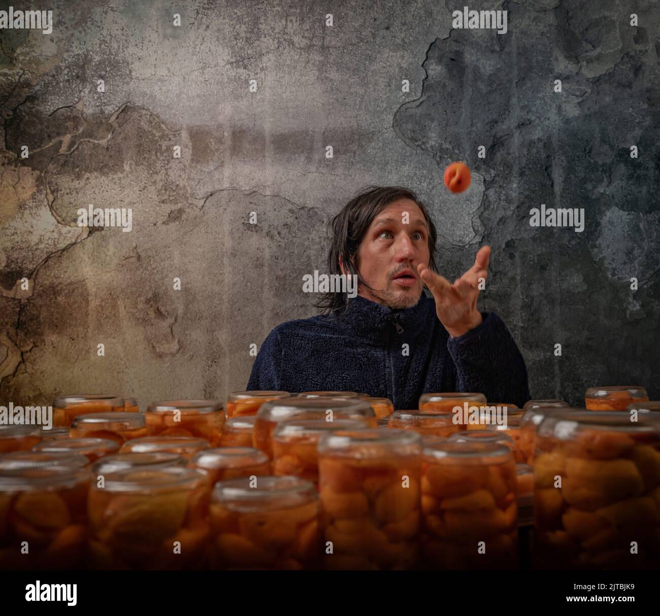 Making of apricot compote on wooden table interior middle of summer in ...