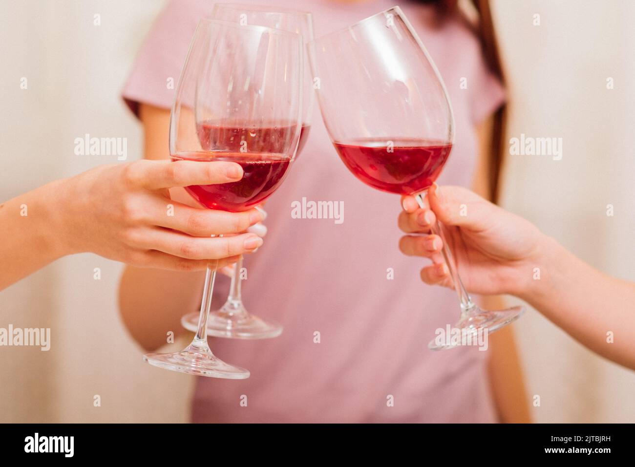 Female friends toasting red wine hi-res stock photography and images - Alamy