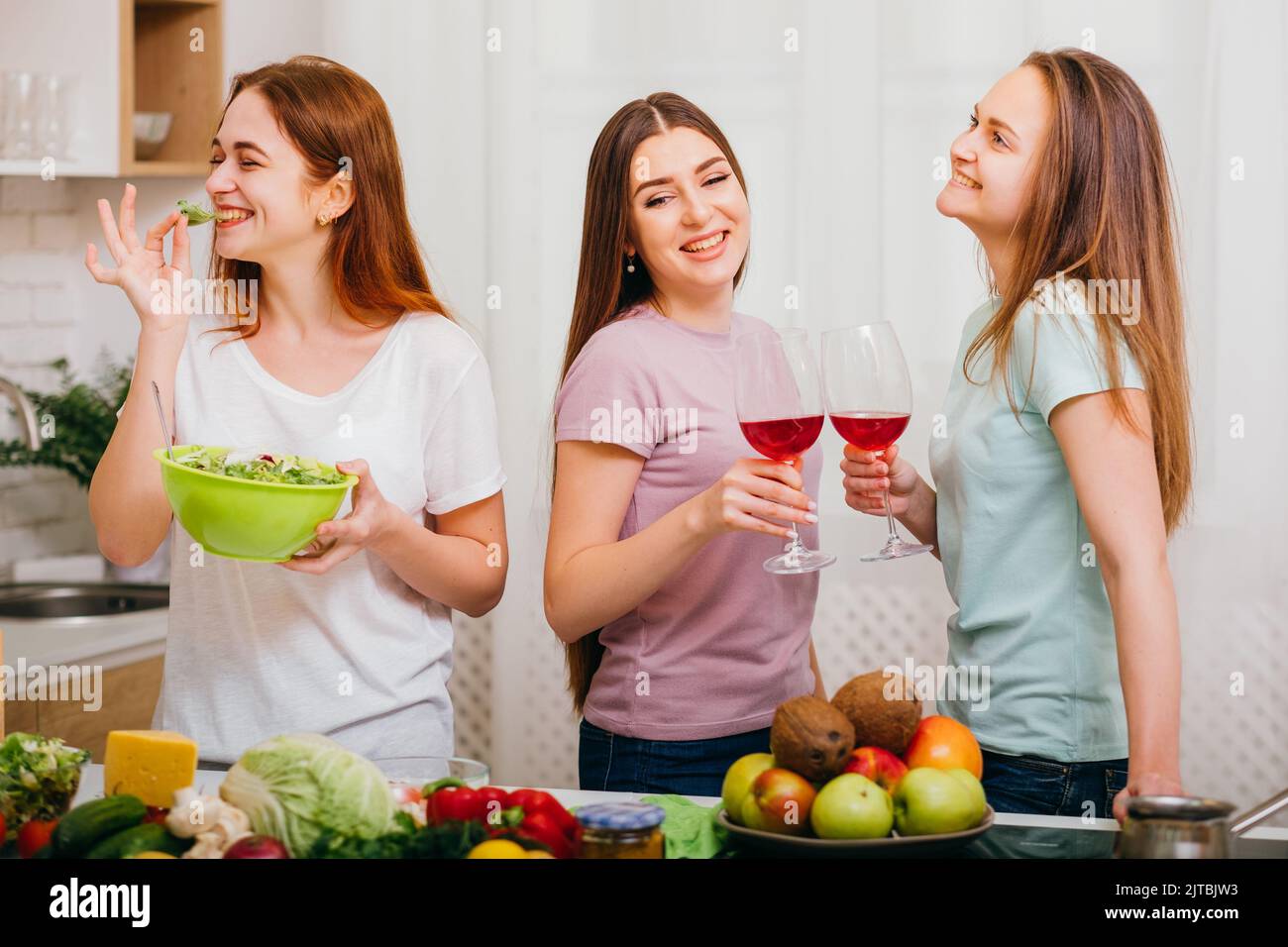 kitchen party fun cooking leisure women wine salad Stock Photo - Alamy