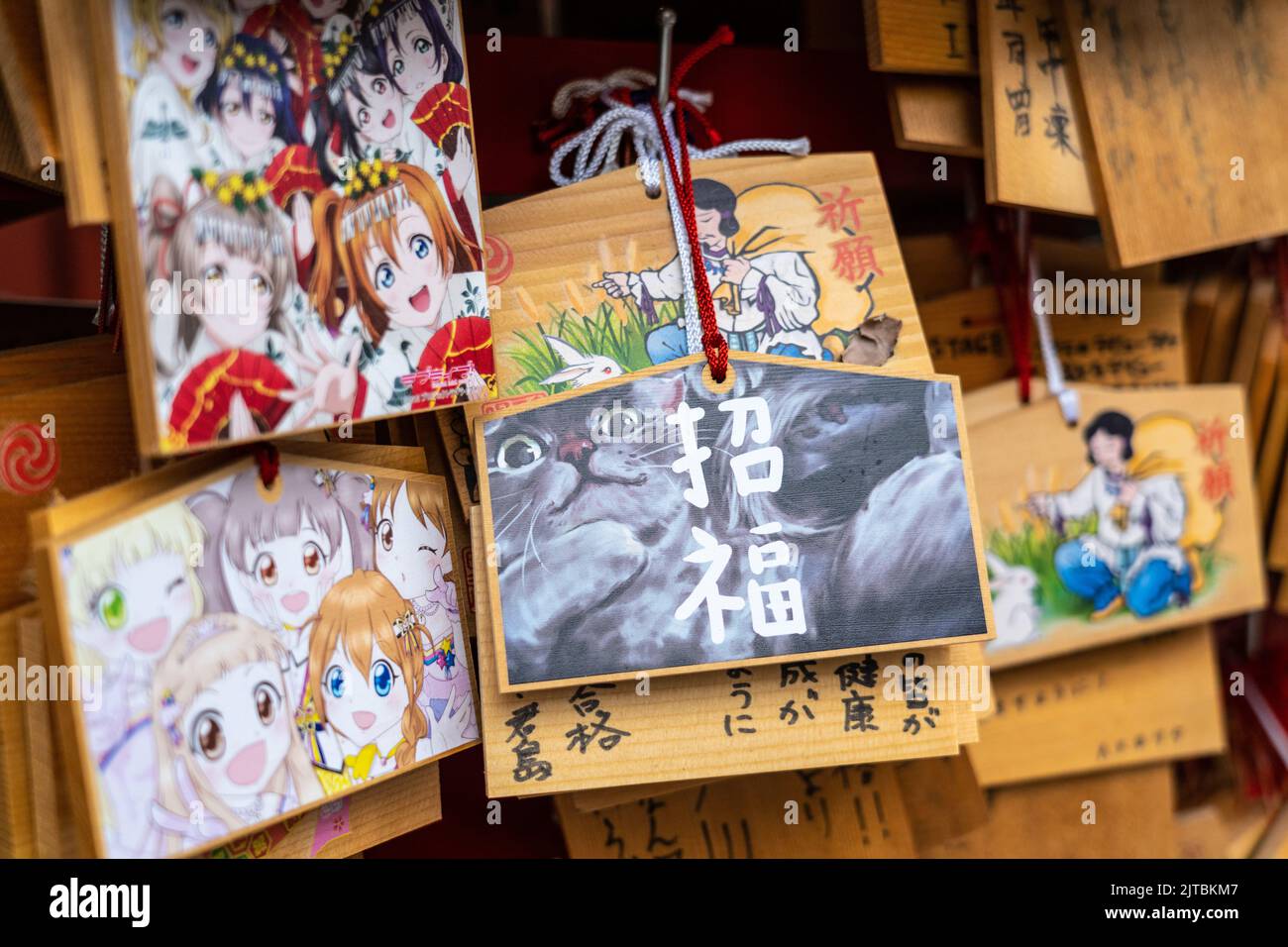 Japanese anime and manga characters painted on ema prayer plaques at ...