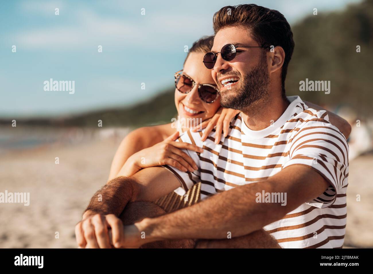 happy couple chilling on summer beach Stock Photo - Alamy