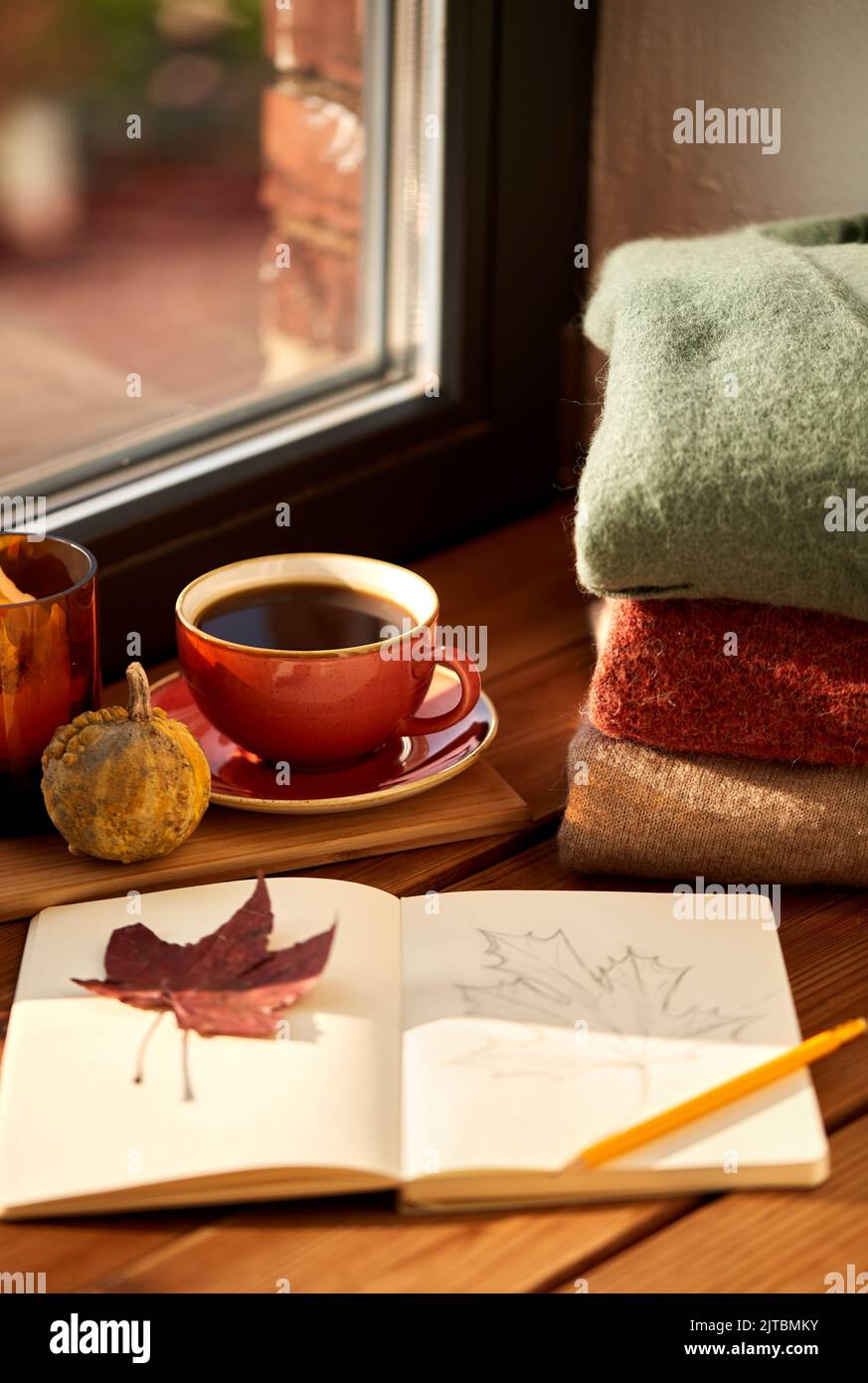sketchbook, autumn leaf and coffee on window sill Stock Photo - Alamy