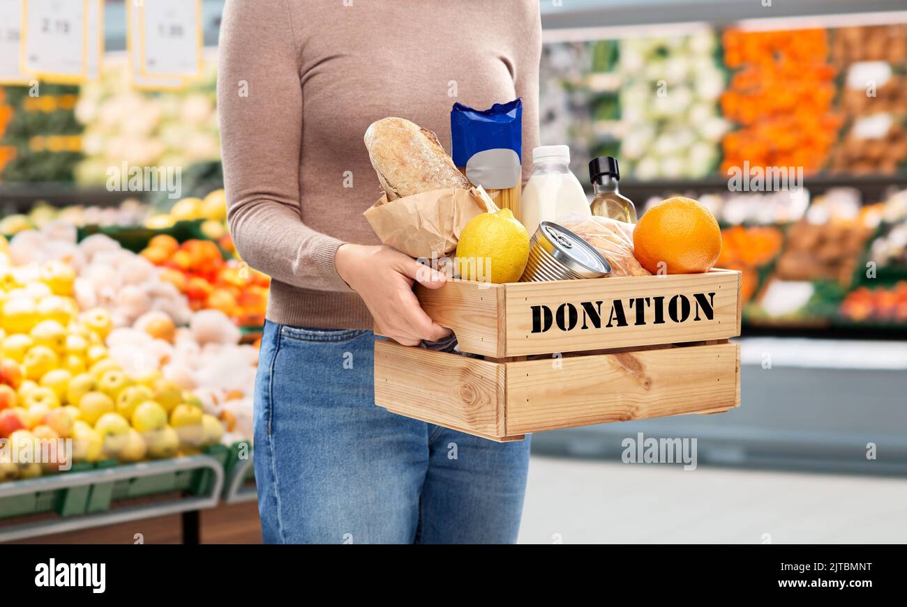 woman holds box with food donation at supermarket Stock Photo - Alamy