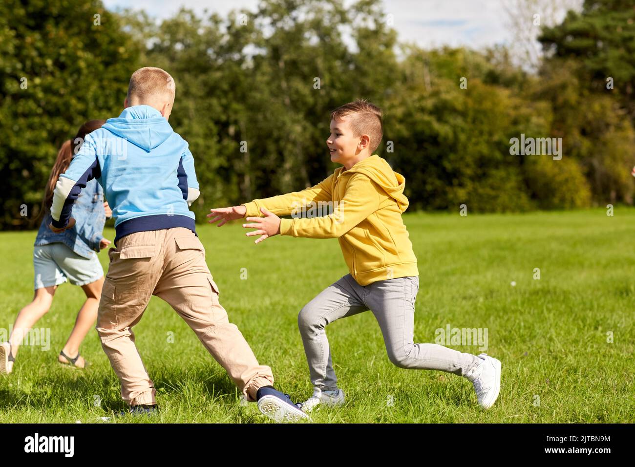 happy children playing and running at park Stock Photo - Alamy