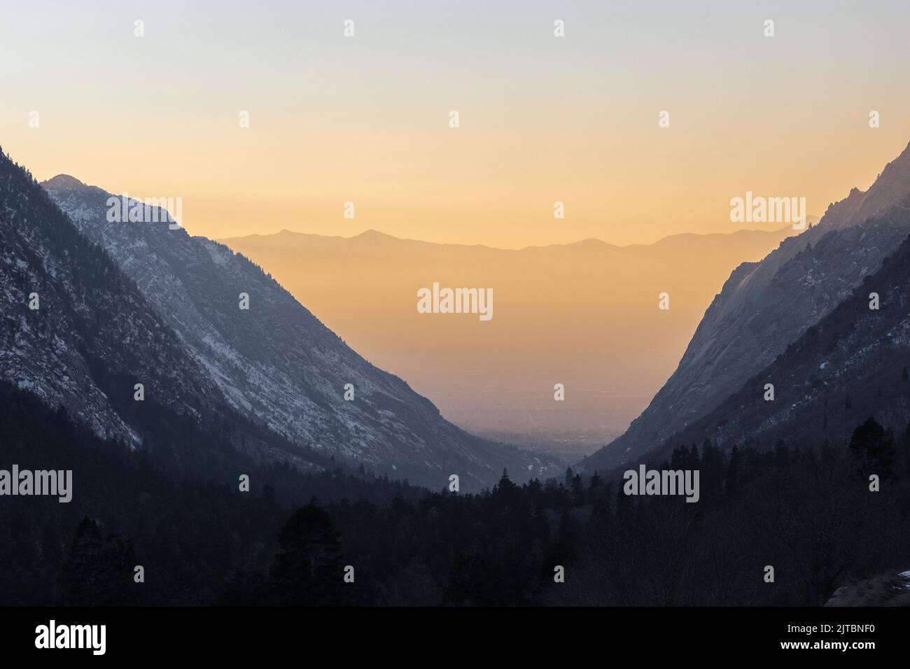 A beautiful view of mountains in Utah covered in conifers and snow at ...