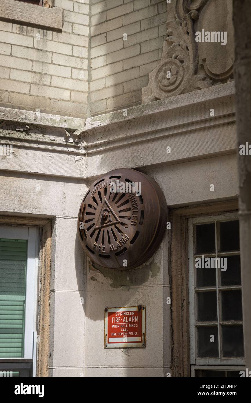 An old building with fire department standpipe connection and bell ...