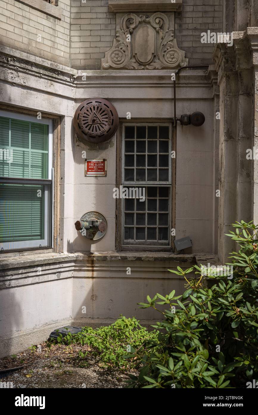 An old building with fire department standpipe connection and bell ...