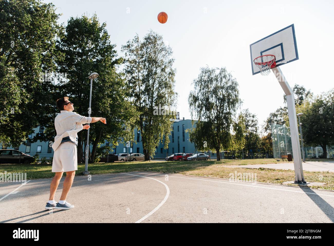 young man playing basketball on outdoor playground Stock Photo - Alamy