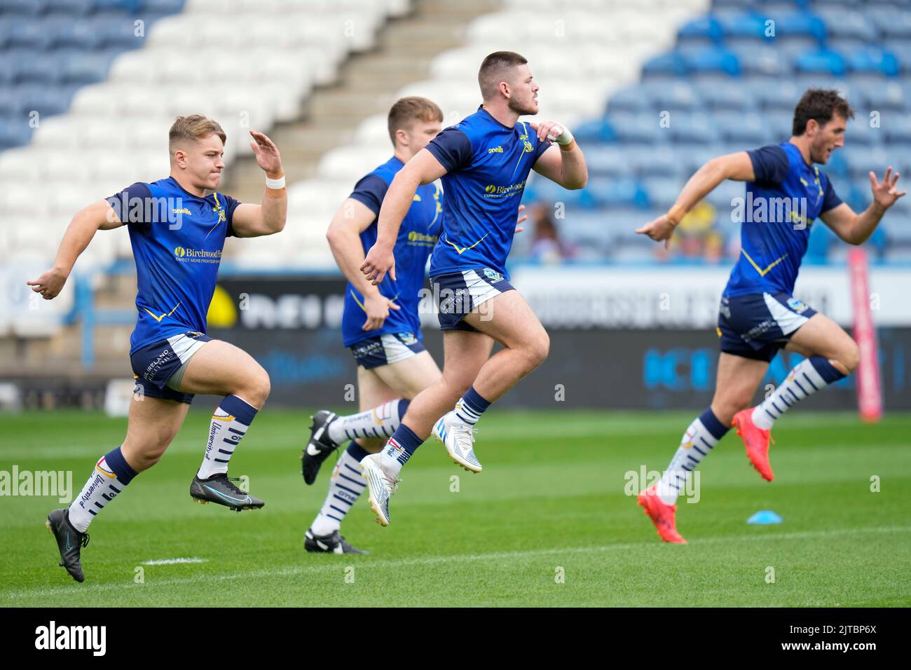 Leon Hayes #39 of Warrington Wolves and Danny Walker warm up before the ...