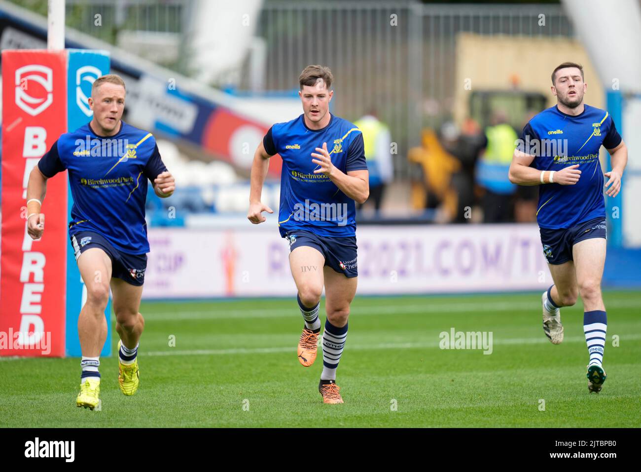 Jason Clark, Riley Dean and Jake Wardle of Warrington Wolves warm up ...