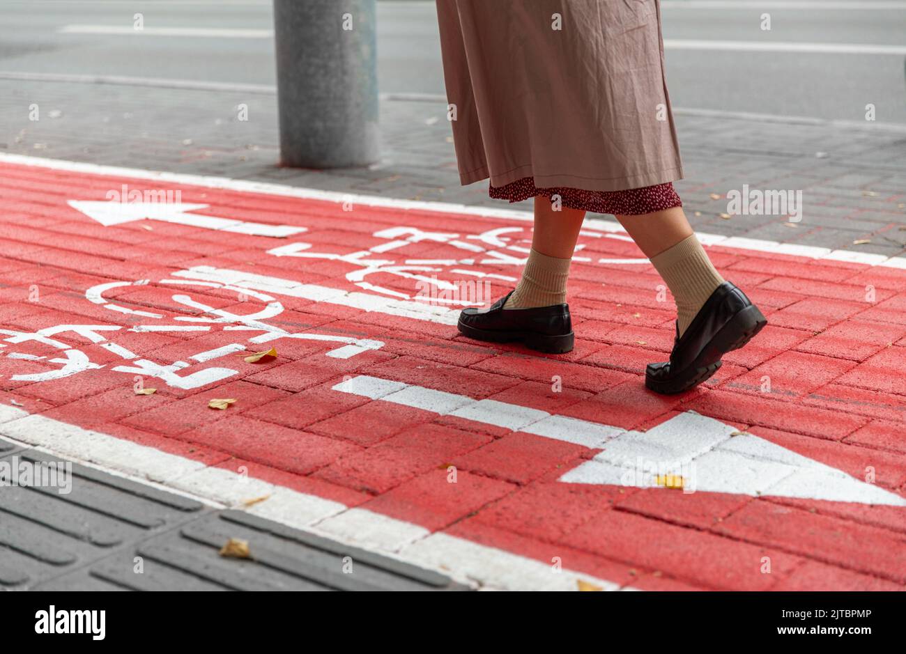 feet walking along bike lane or road for bicycles Stock Photo - Alamy