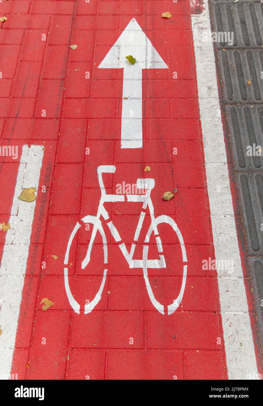 bike lane or red road with signs of bicycles Stock Photo - Alamy