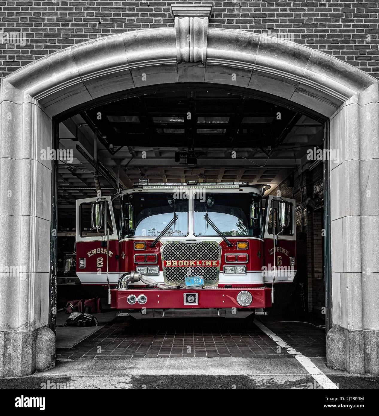 A fire engine sitting ready in a station Stock Photo - Alamy